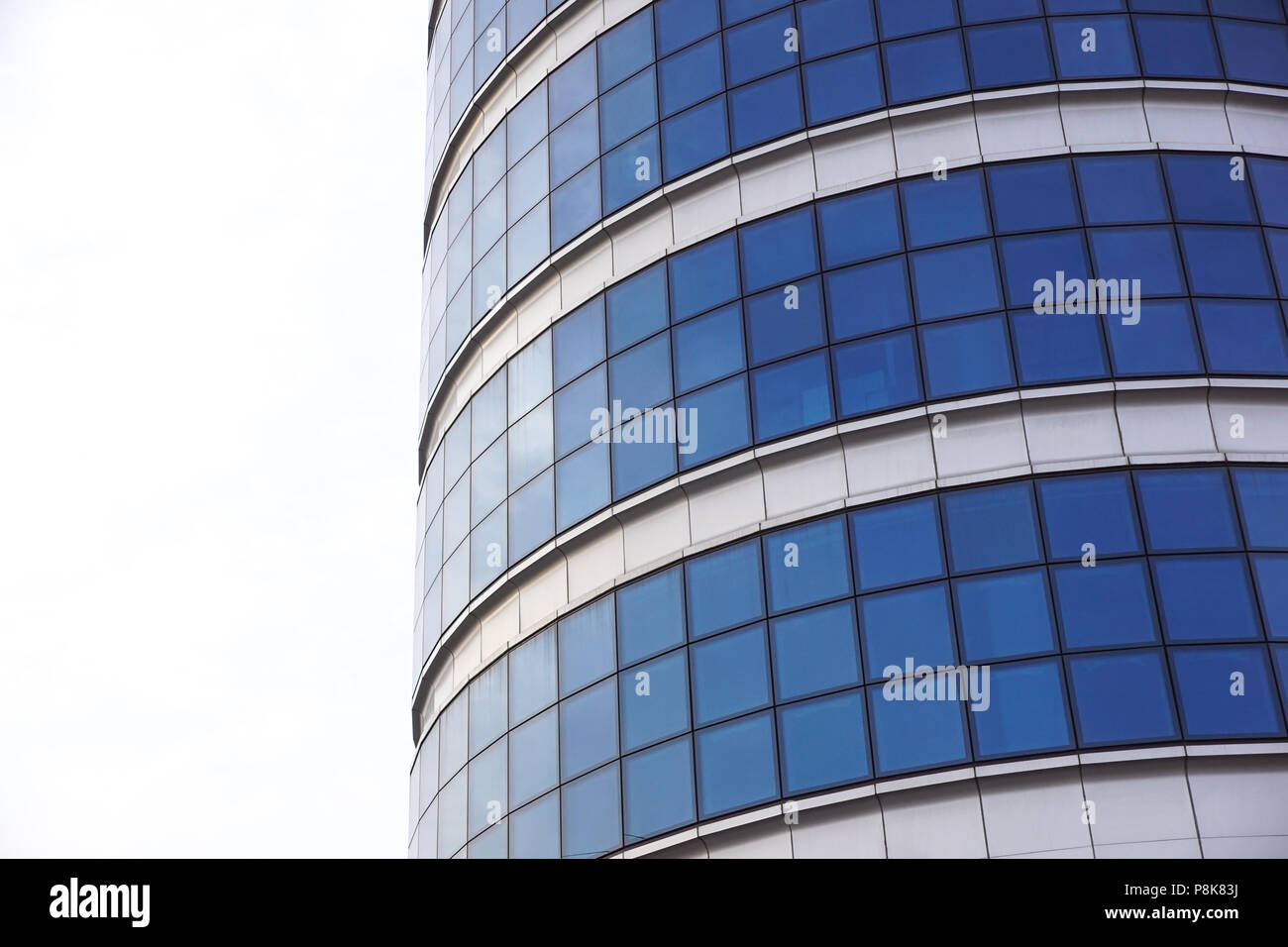 Reflexion of blue sky with clouds in building windows. Vertical view ...