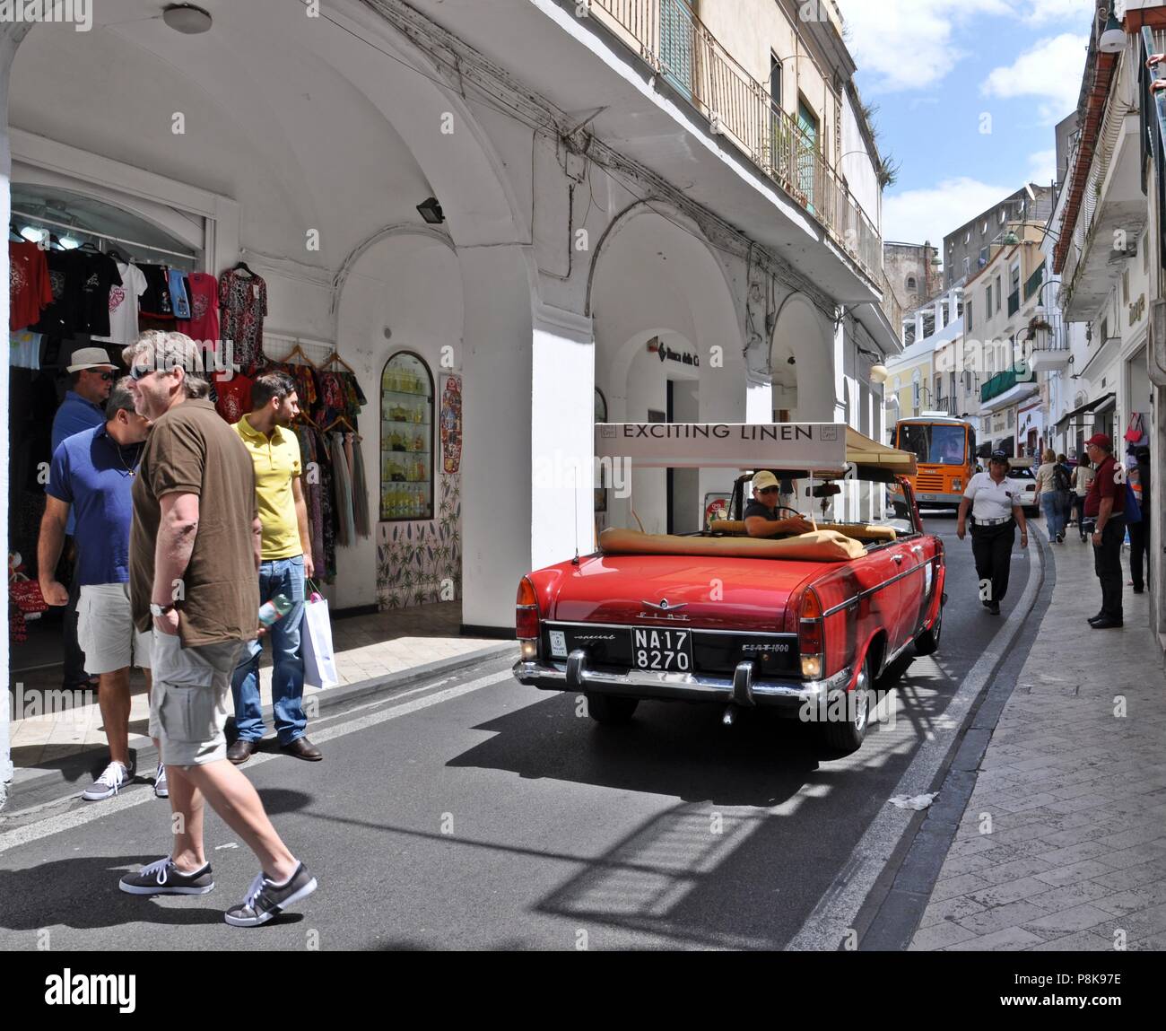 People walking on the narrow white shopping street, with a shop on the ...