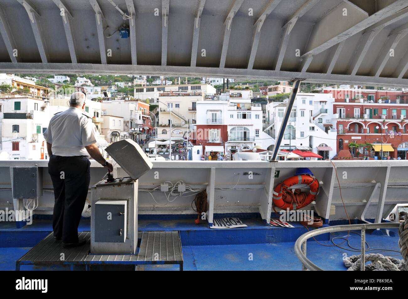 Capri, Italy - May 18, 2013: Captain of the ship stands at the command ...