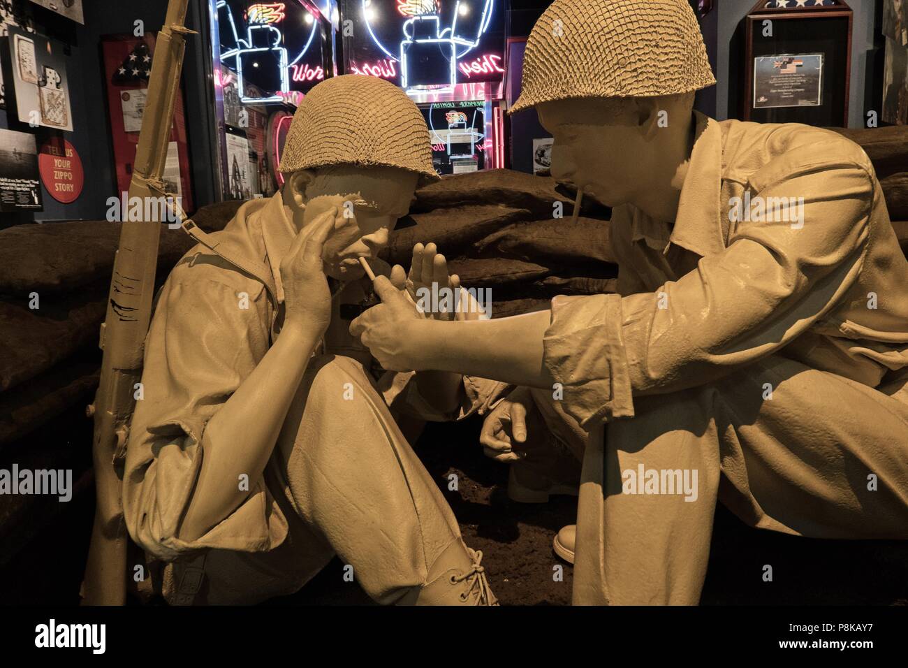 A statue of two World War II infantry man sharing a smoke and using a ...