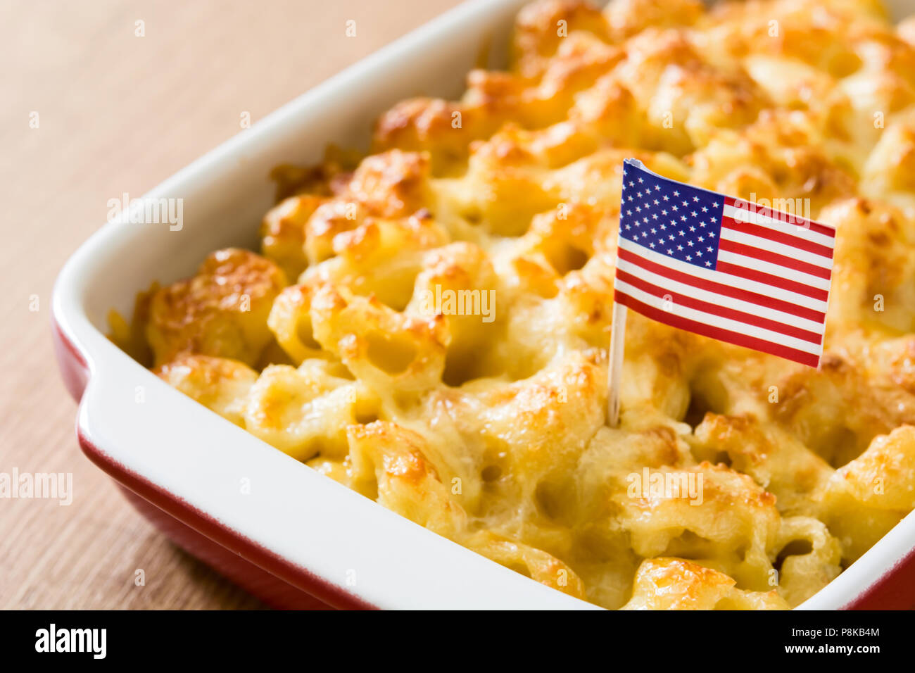 Typical American macaroni and cheese with USA flag on wooden table ...
