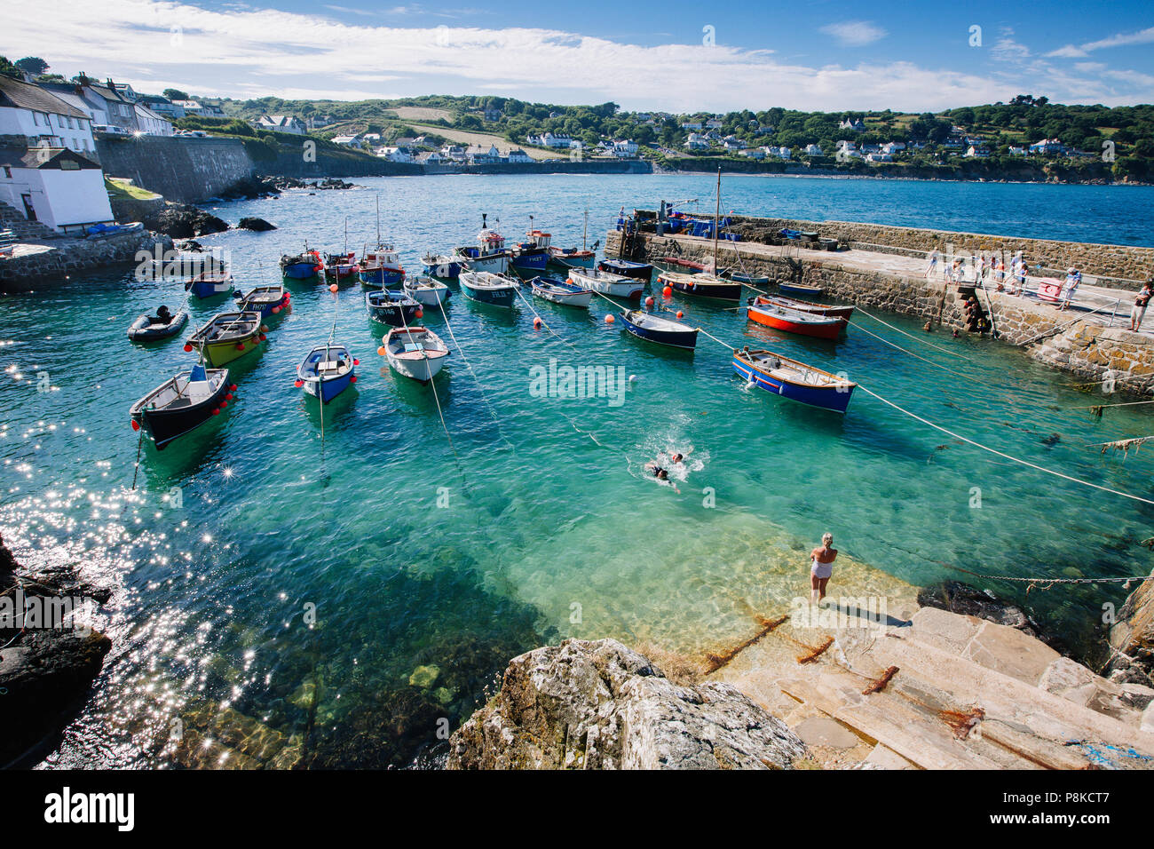 A picturesque view of traditional Cornish fishing boats floating in the ...