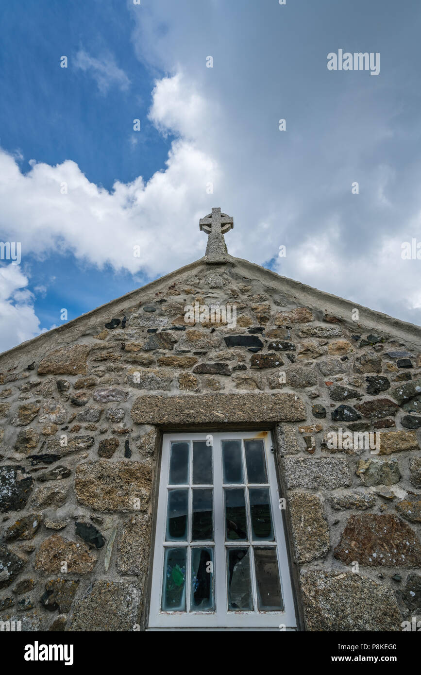 Large window and a small cross on top of a small Catholic church Stock ...