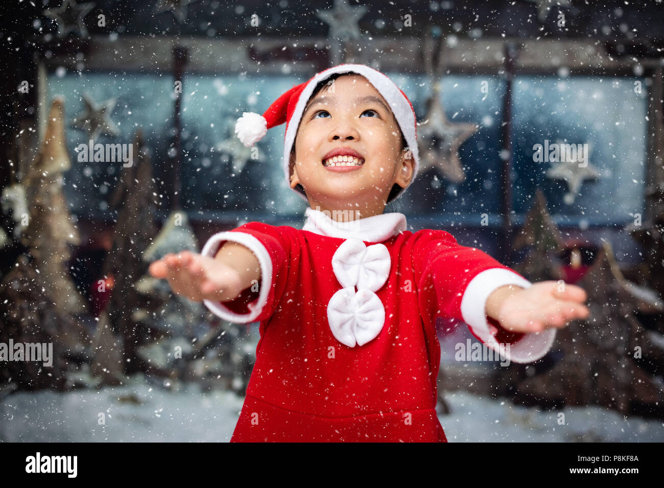 Asian Chinese little girl playing with snowflakes outdoor during ...