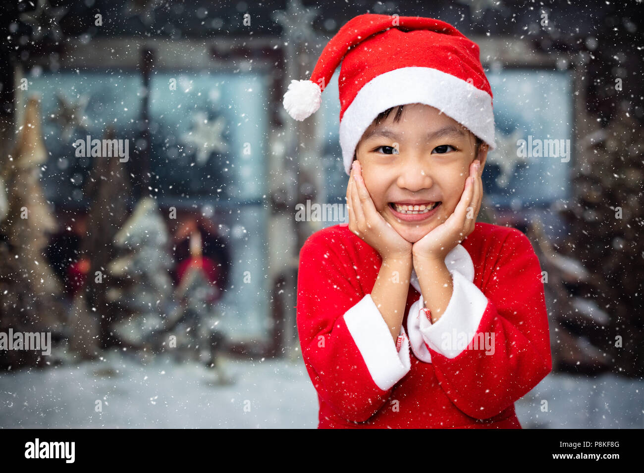 Asian Chinese little girl playing with snowflakes outdoor during ...
