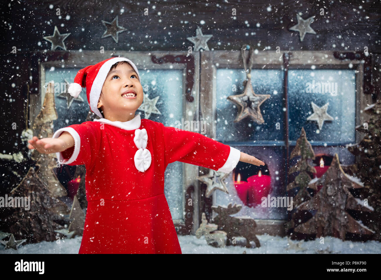 Asian Chinese little girl playing with snowflakes outdoor during ...