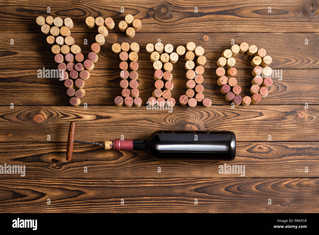 Vino lettering with bottle of wine against wooden background Stock ...