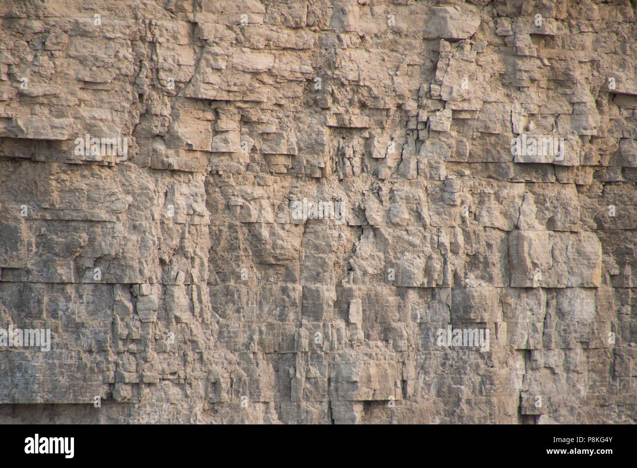 Closeup limestone rock face showing weathered strata and details for ...
