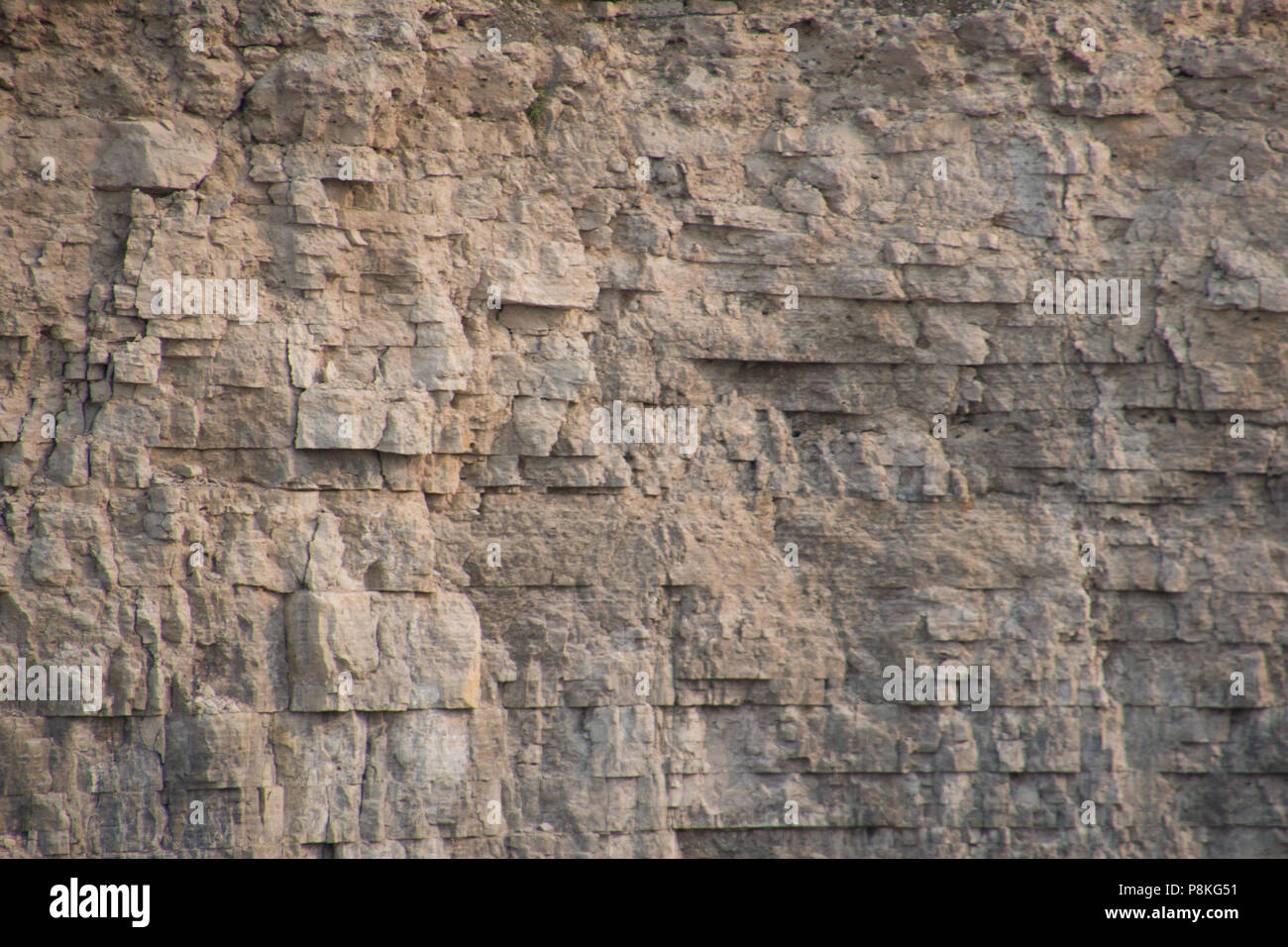Closeup limestone rock face showing weathered strata and details for ...