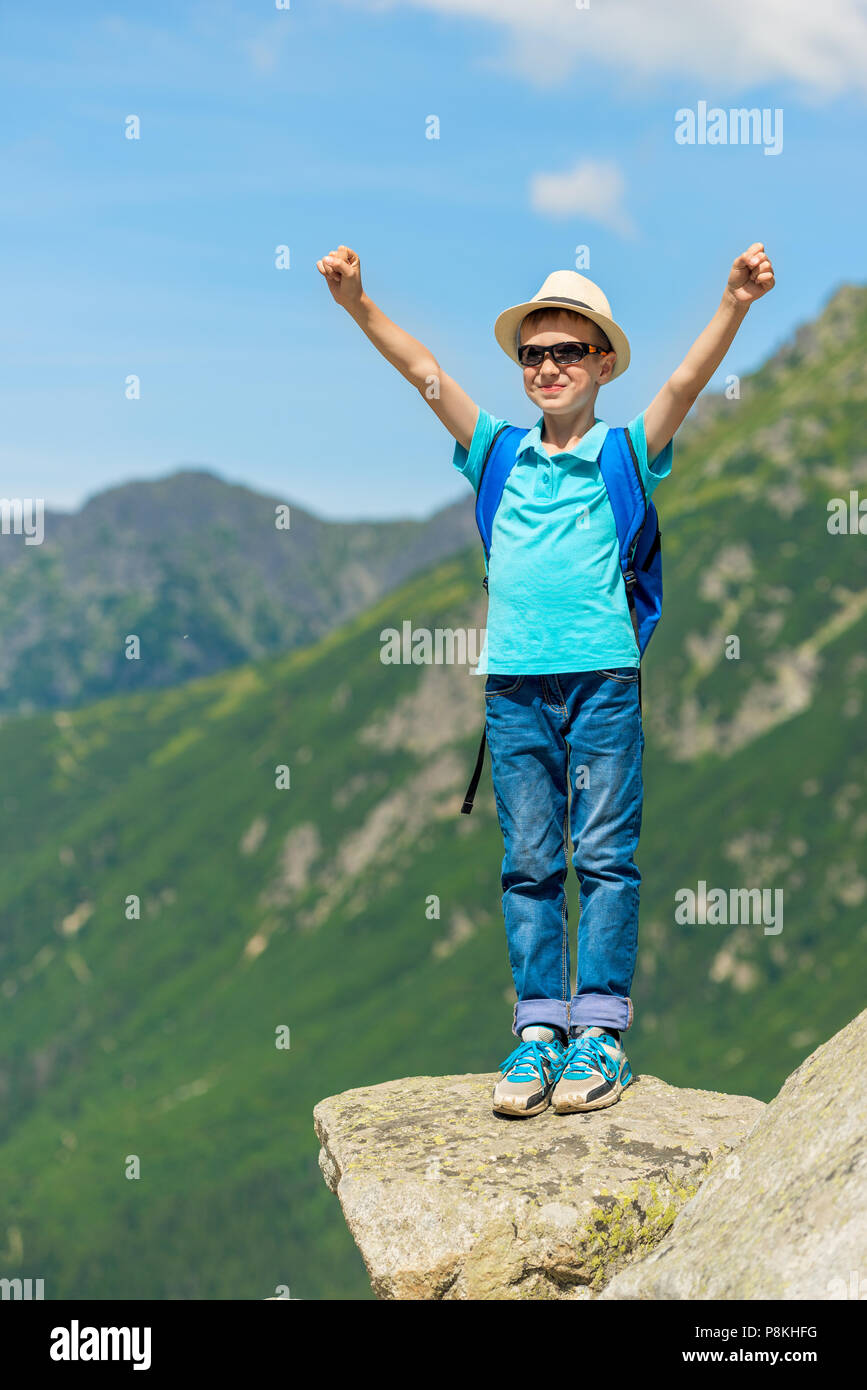 traveler boy enjoys the beauty of the mountains and freedom Stock Photo ...