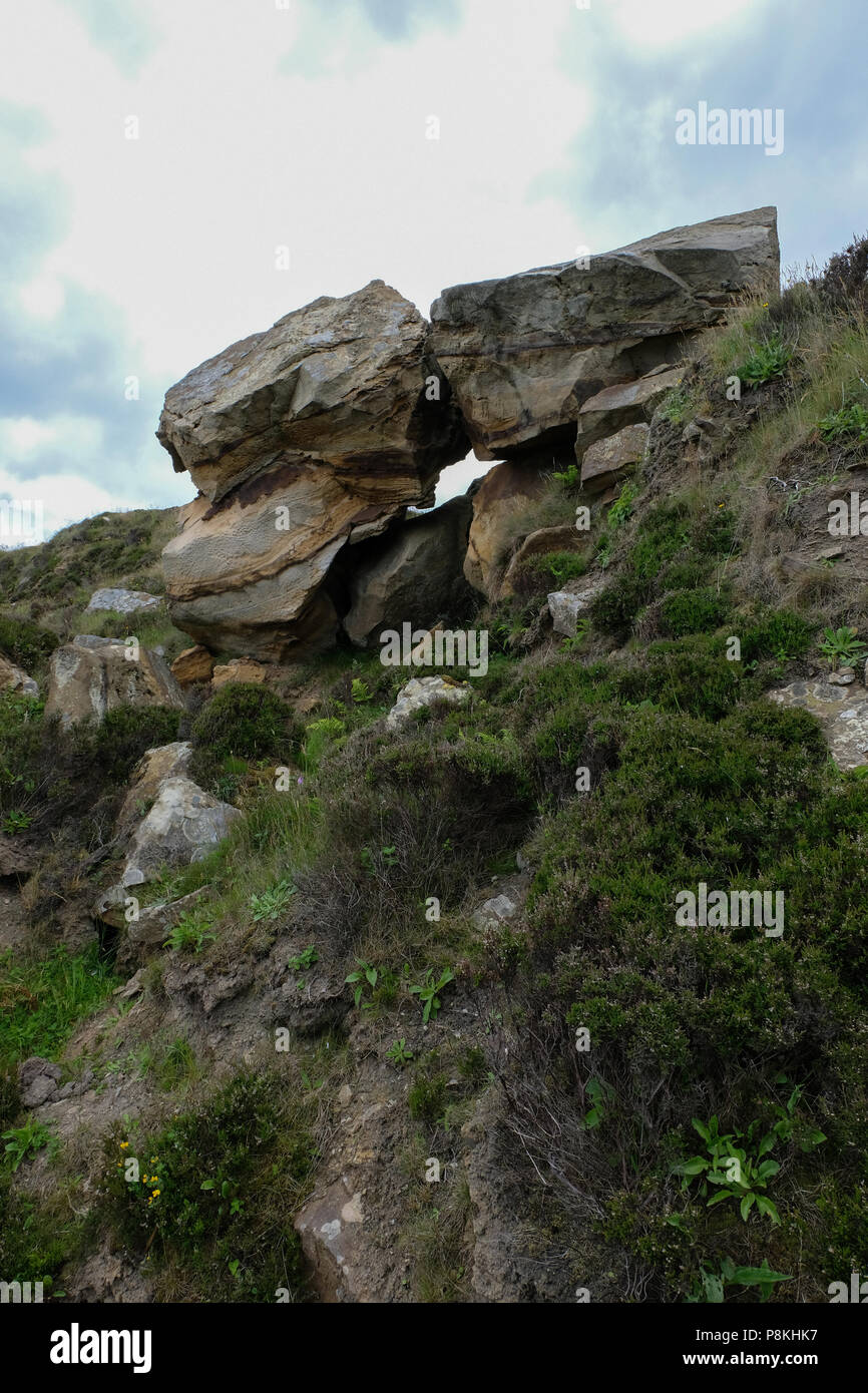 Looking up towards some large boulders on the hill after older ...