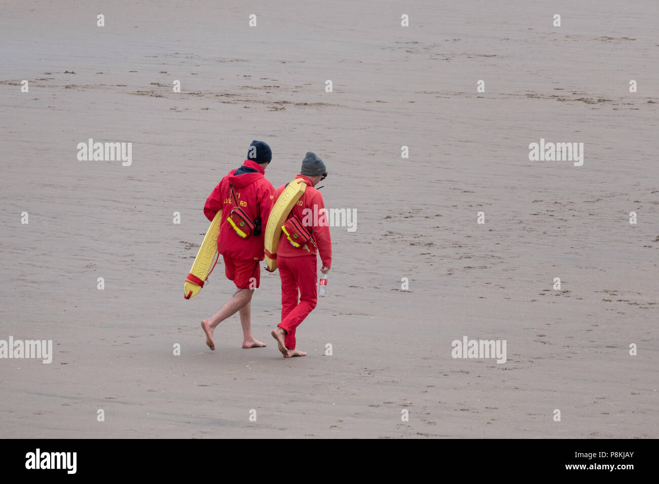 Two lifeguards patrol the beach on South Bay, Scarborough, Yorkshire ...