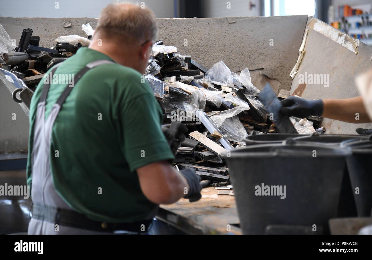 Krefeld, Germany. 12th July, 2018. Workers sort types of batteries in ...