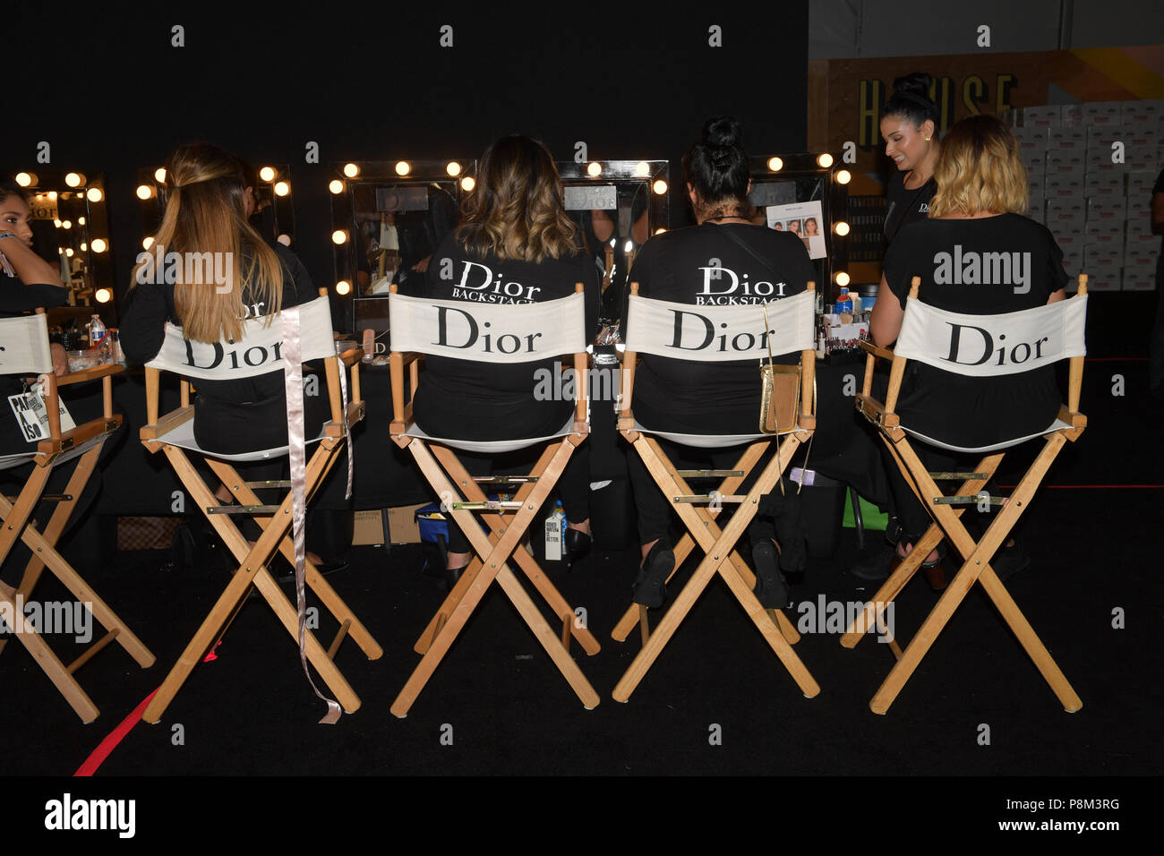 MIAMI BEACH, FL - JULY 12: Models back stage and walking the runway for ...