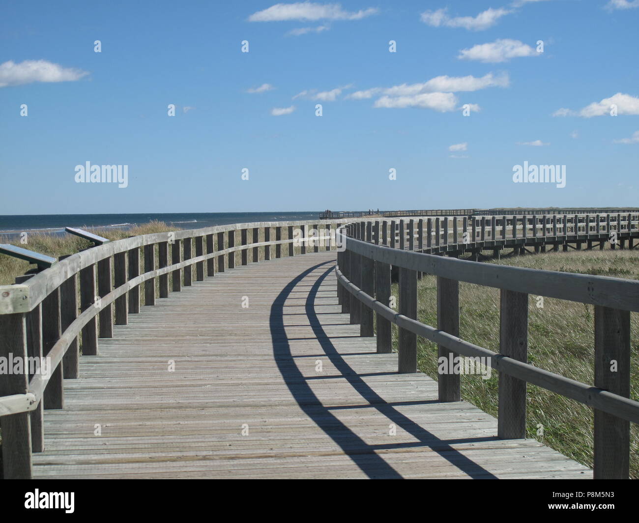 Wooden boardwalk with railing Stock Photo - Alamy