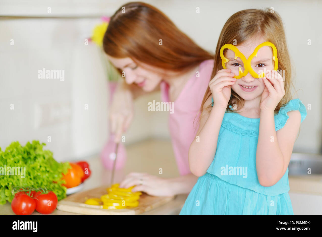 Mother and daughter cooking dinner in a kitchen Stock Photo - Alamy