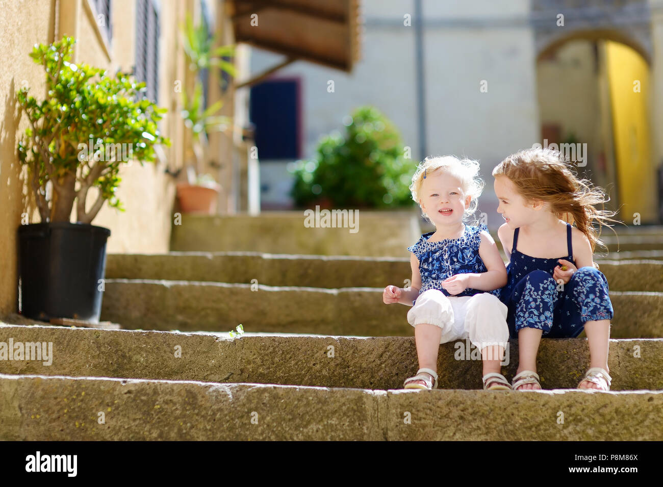 Two sisters sitting on stairs hi-res stock photography and images - Alamy