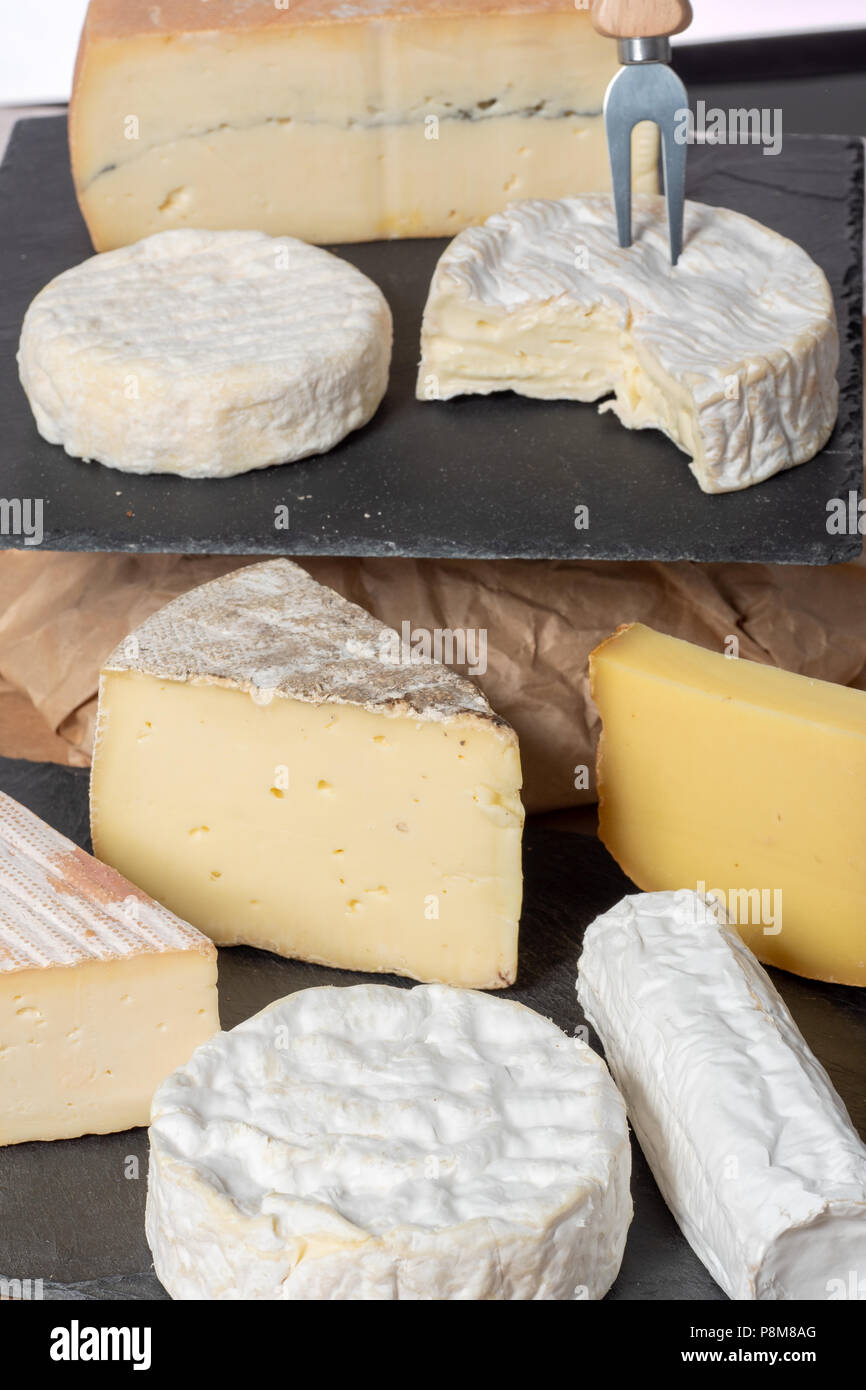 the different french cheeses on slate plate Stock Photo - Alamy