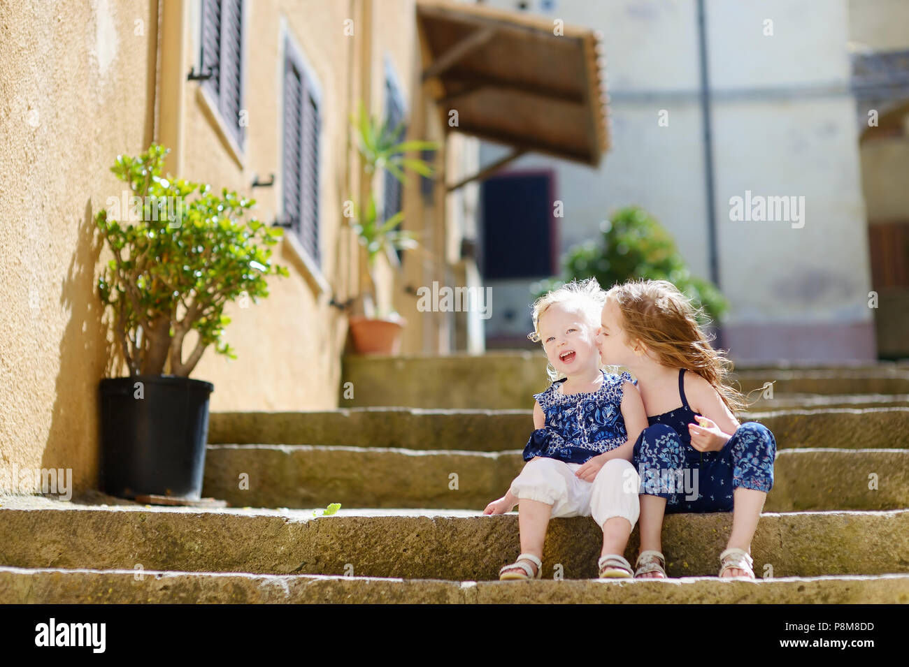 Two sisters sitting on stairs hi-res stock photography and images - Alamy