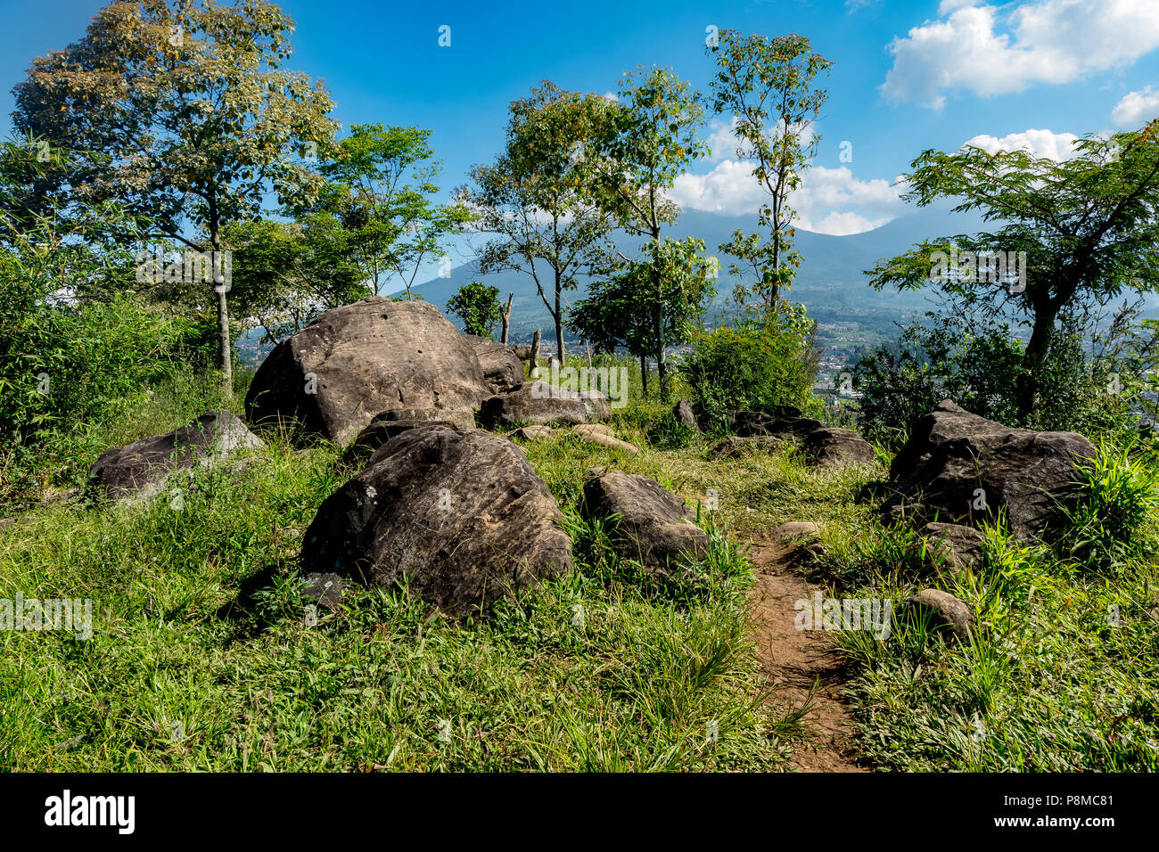 Stone formation at the top of the hill, surrounded by grass Stock Photo ...