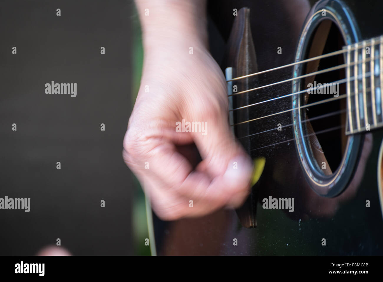 Guitar player with the guitar in hand Stock Photo - Alamy