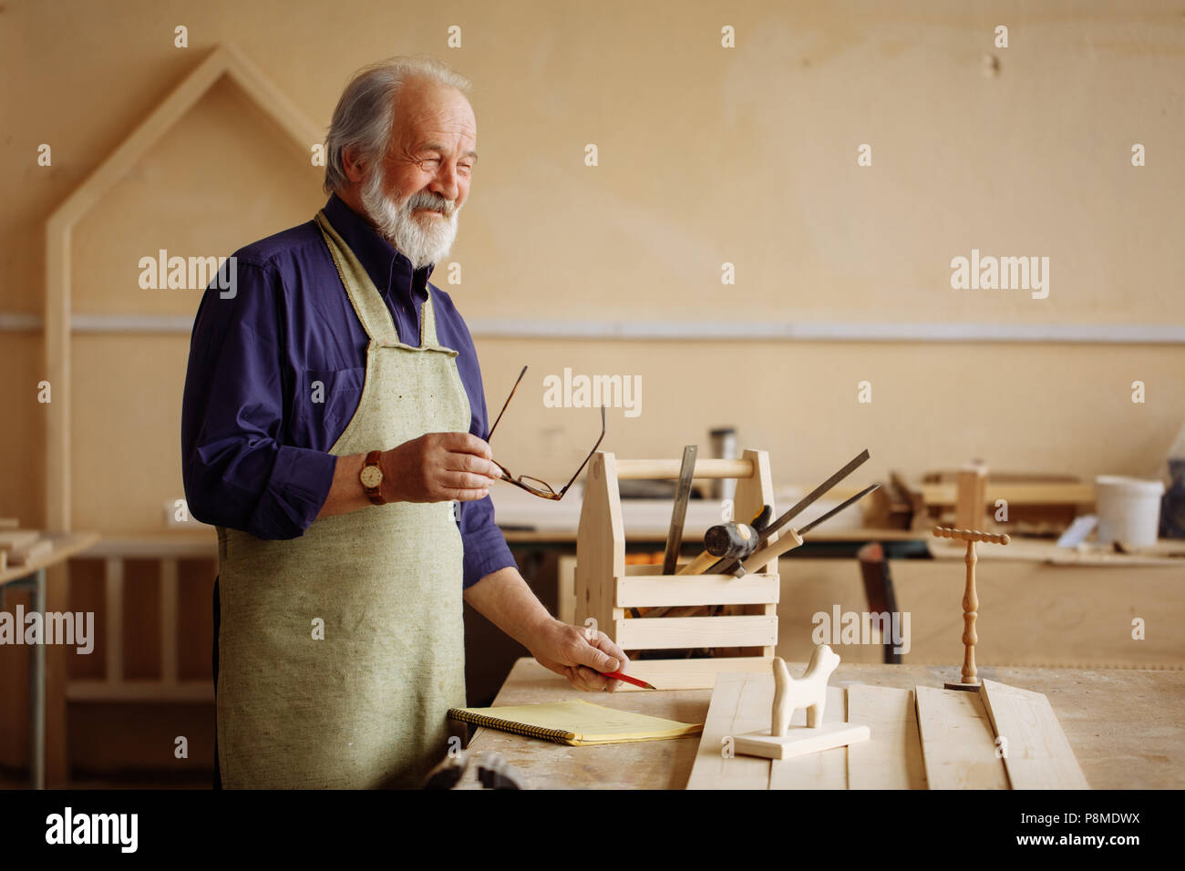 laughing old master loves his work. making handmade products Stock ...