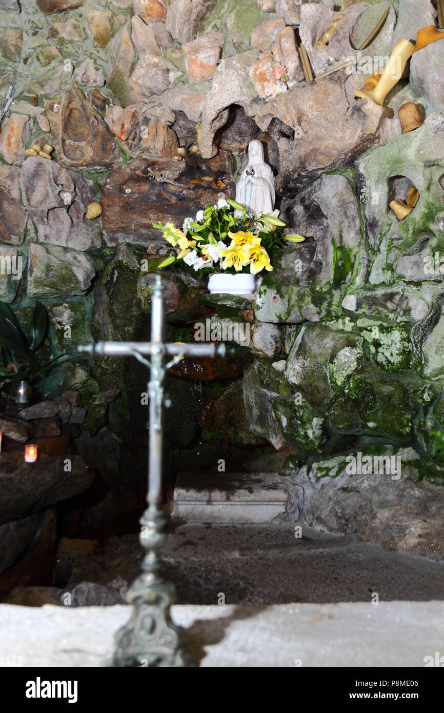 Virgen of Lourdes statue, spring and wax body parts in grotto on Monte ...