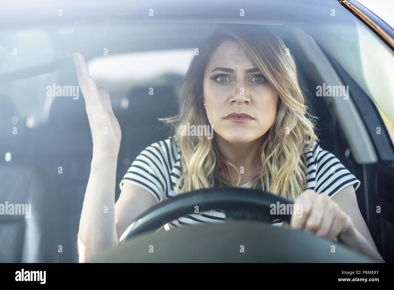 Angry woman driving a car Stock Photo - Alamy