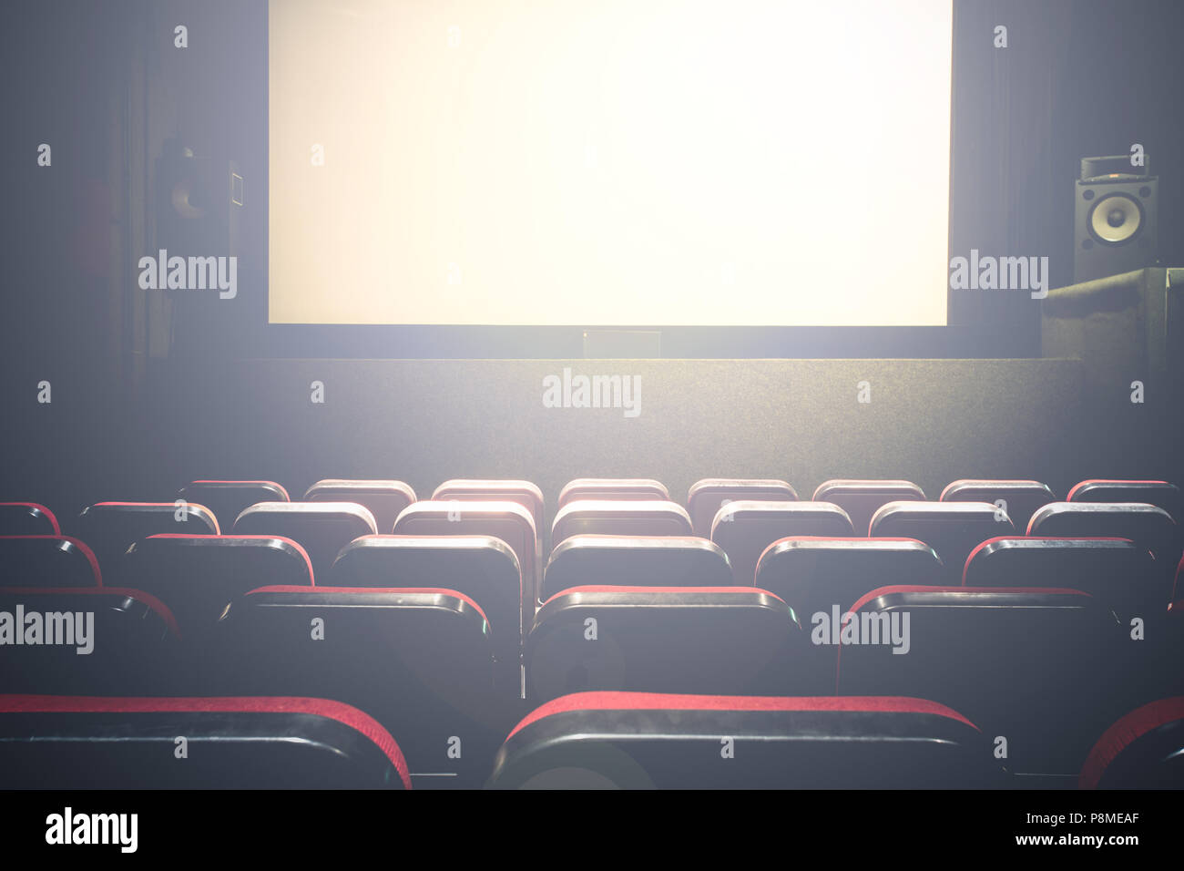 Movie Cinema hall with a white empty screen premiere with red seats ...