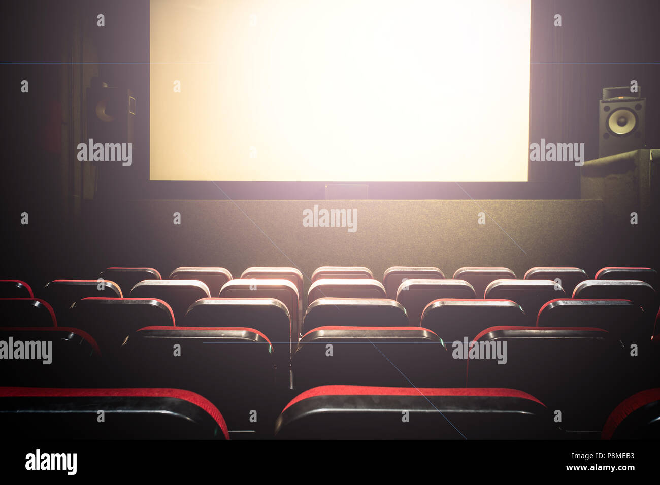 Movie Cinema hall with a white empty screen premiere with red seats ...