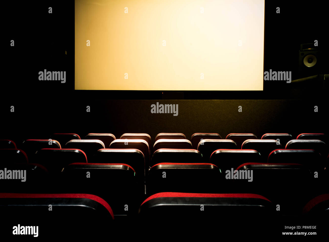 Movie Cinema hall with a white empty screen premiere with red seats ...