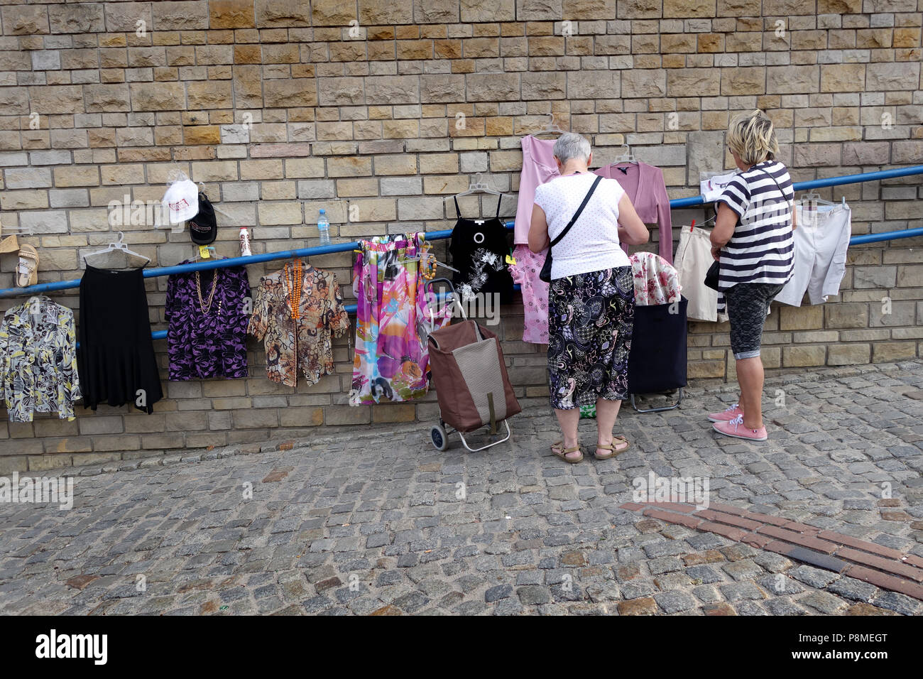 Street trader selling clothes on railing Wrocław Poland Stock Photo - Alamy