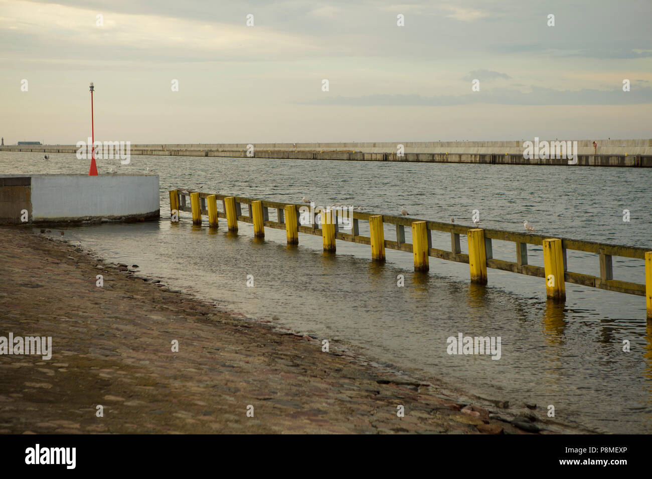 red navigational lantern and yellow pales in sea harbour Stock Photo ...