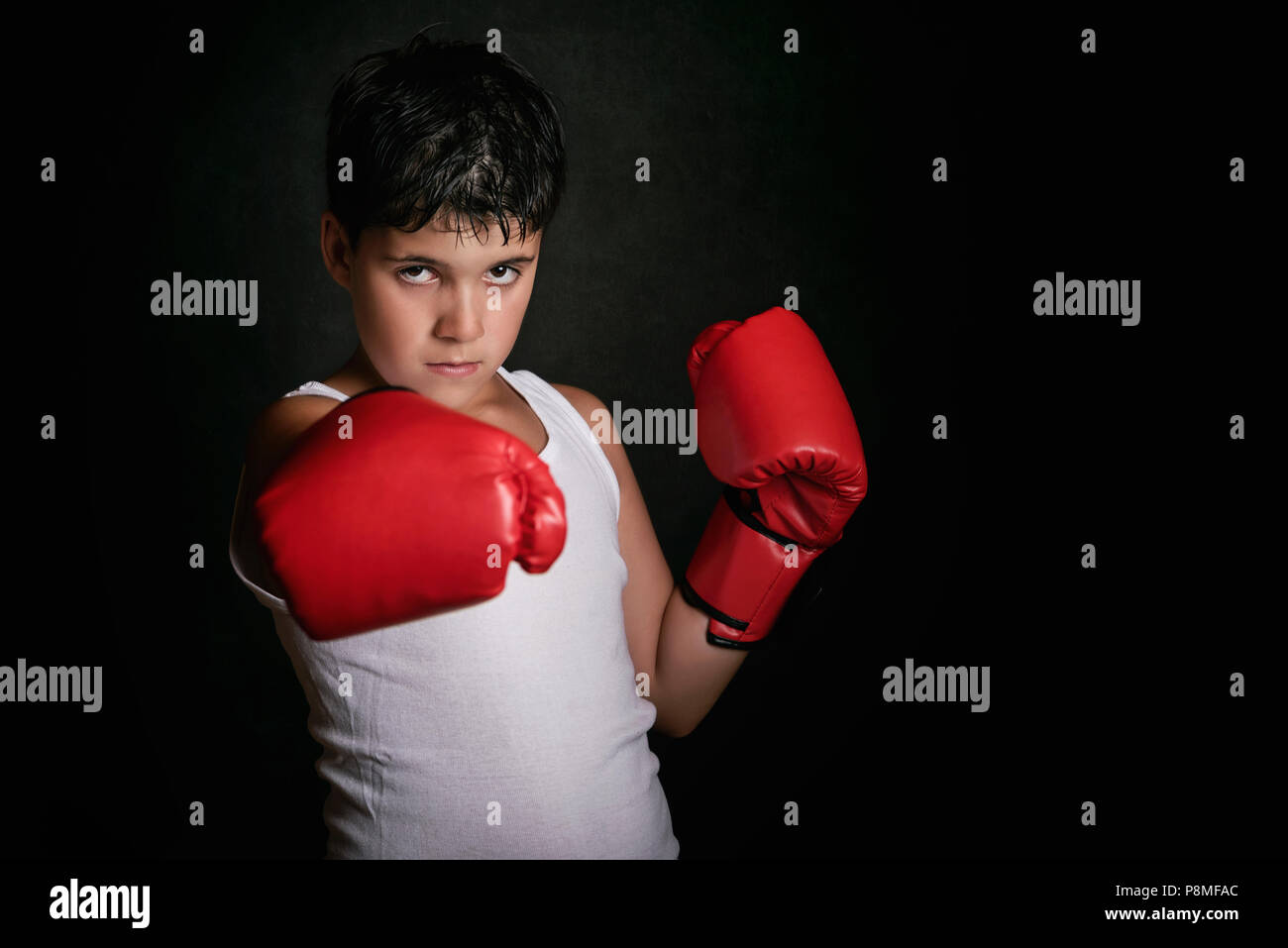 little boy with boxing gloves on black background Stock Photo - Alamy