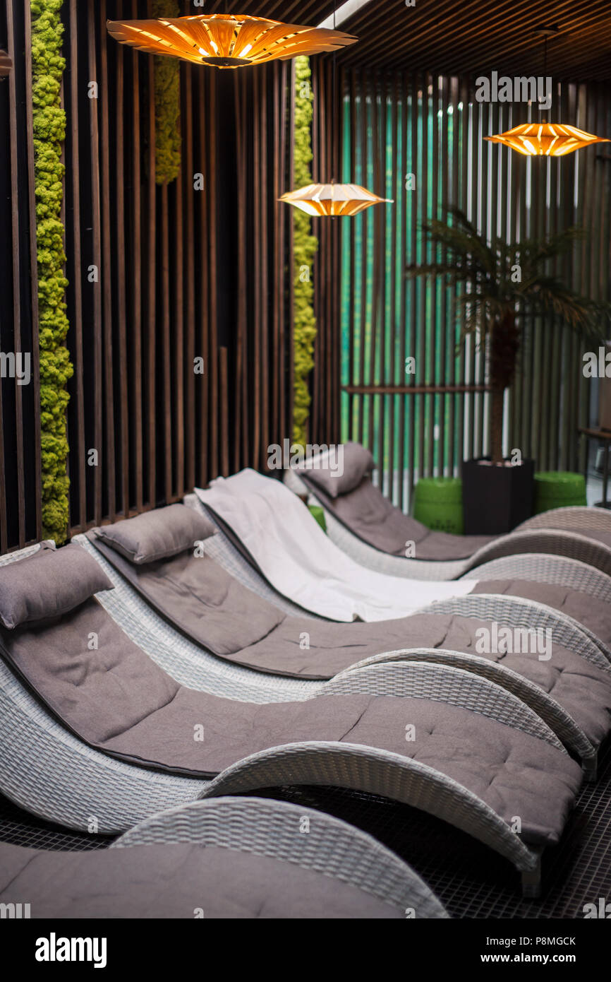 close up photo of modern interior of spa center with loungers ...