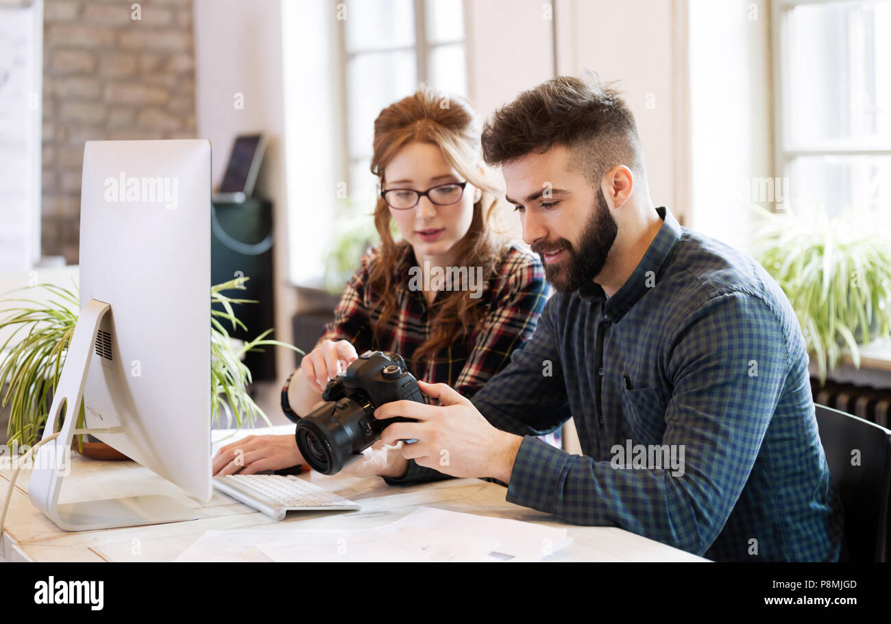 Two young designers working in modern office Stock Photo - Alamy