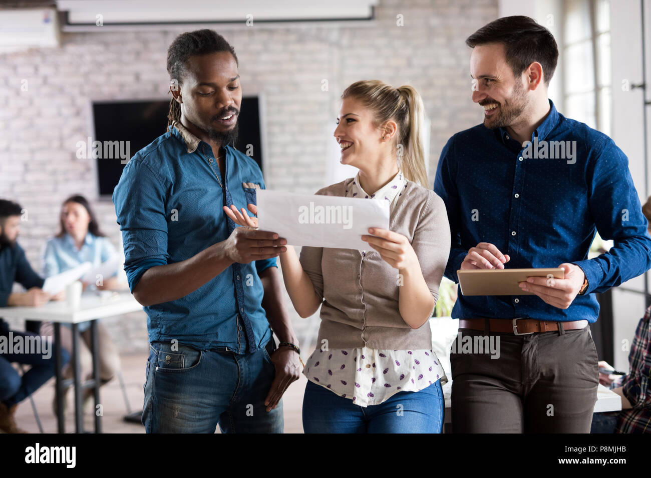 Smiling diverse businesspeople having discussion hi-res stock ...