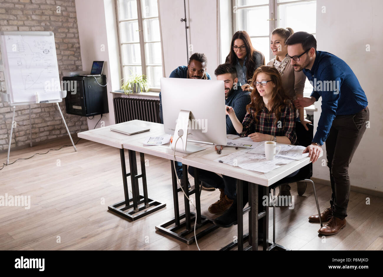 Young architects working on project in office Stock Photo - Alamy