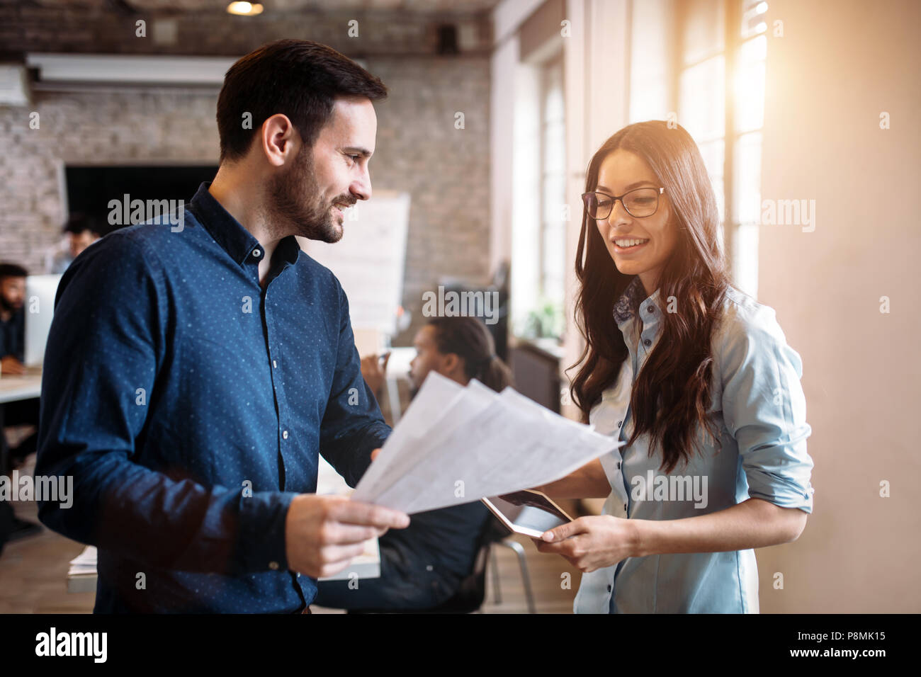 Portrait of architects having discussion in office Stock Photo - Alamy