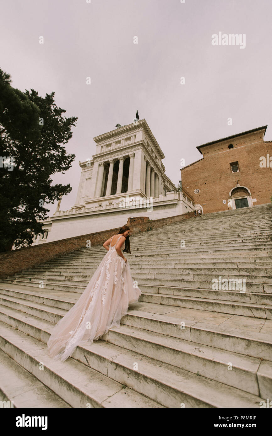 Bride in wedding dress on stairs of Cordonata Capitolina in Rome, Italy ...