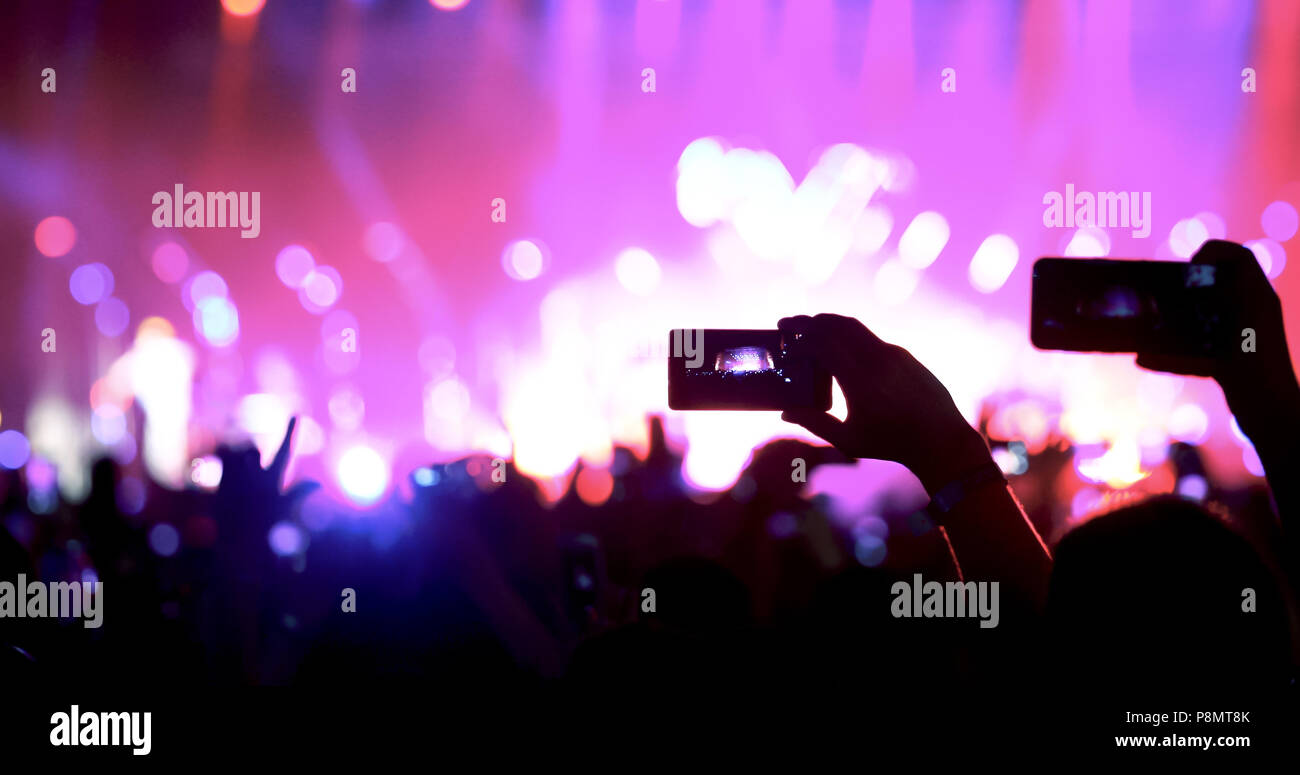 Fan taking photo of concert Stock Photo - Alamy