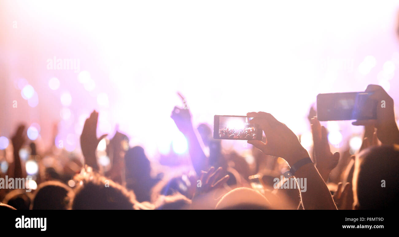 Fan taking photo of concert Stock Photo - Alamy