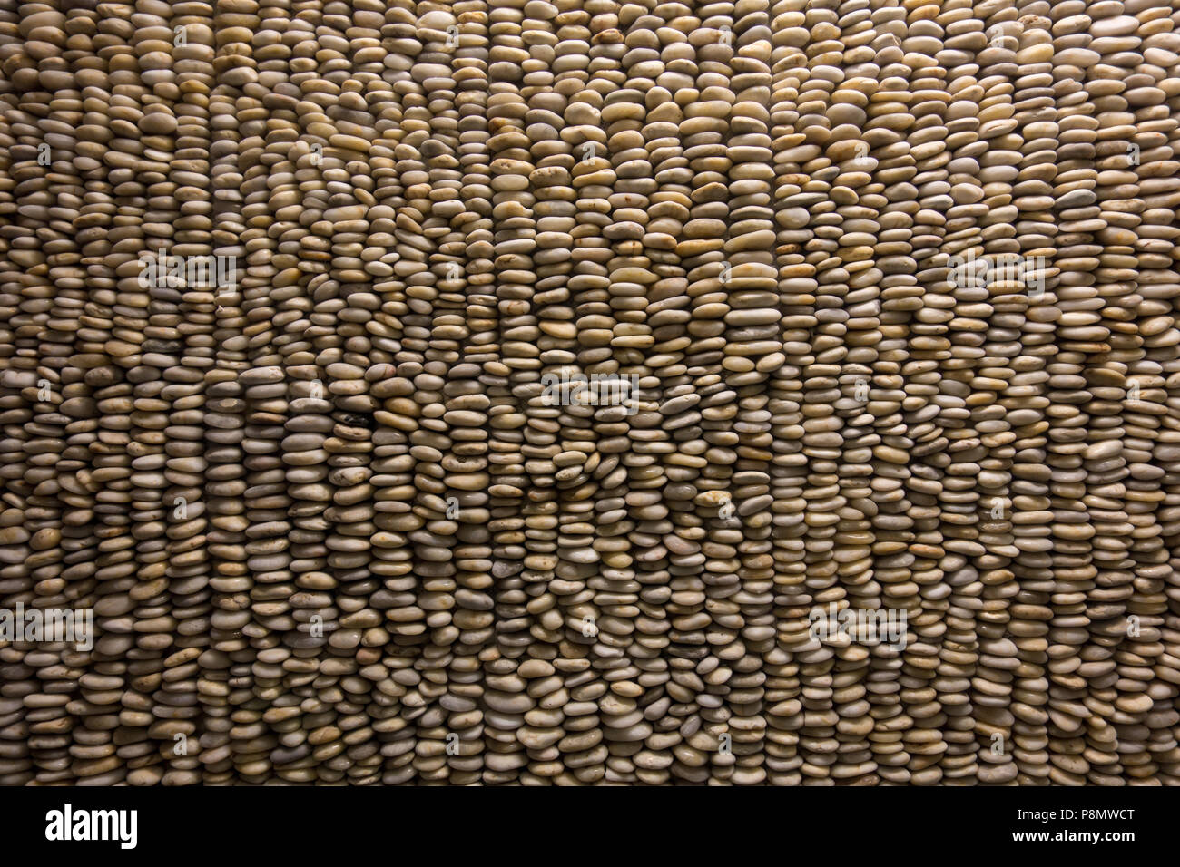 Surface of a wall from a pebble Stock Photo - Alamy