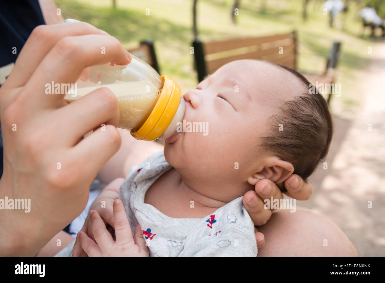 A portrait of cute newborn baby being fed using baby bottle Stock Photo ...