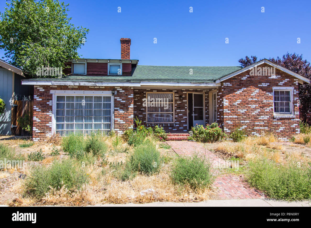 Abandoned One Level Home With Overgrown Front Yard Stock Photo - Alamy