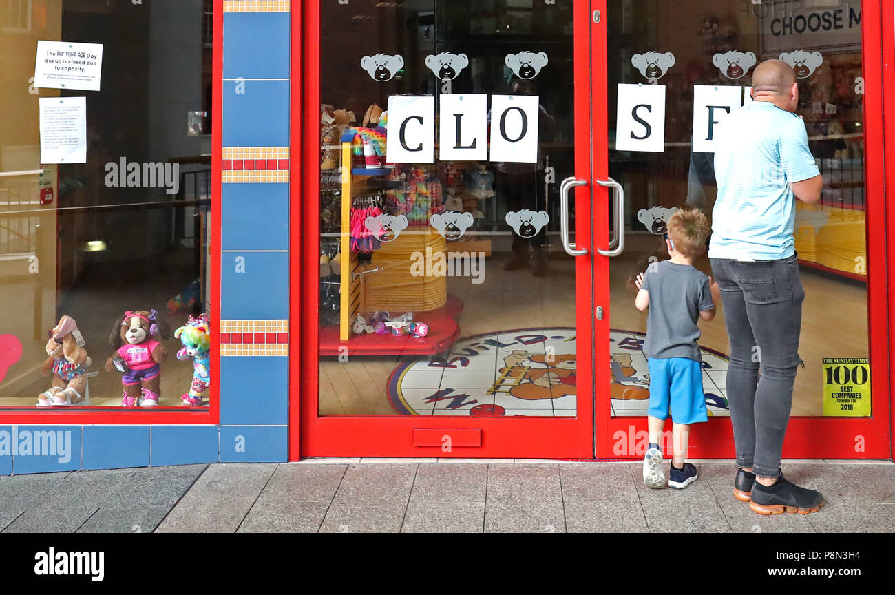 Passers by look into the the Build-A-Bear store in Belfast which had to ...