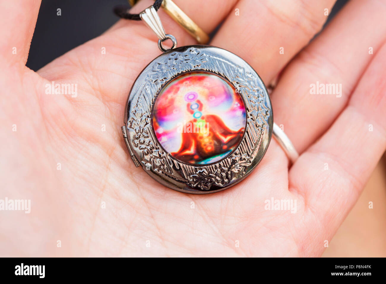 Little pendant jewellery with colorful esoteric design Stock Photo - Alamy