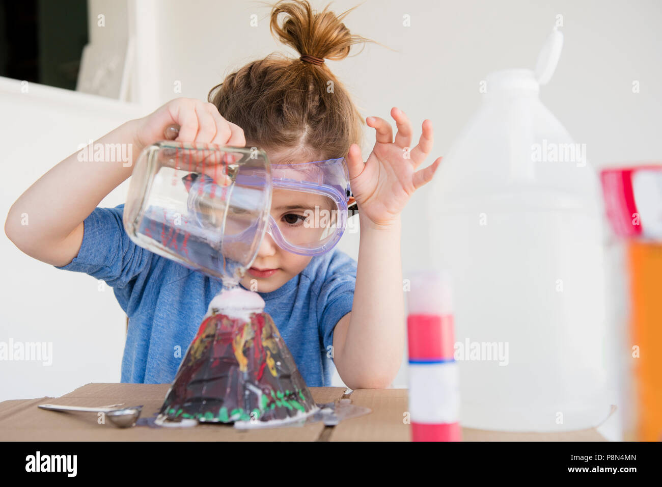 Girl making volcano Stock Photo - Alamy