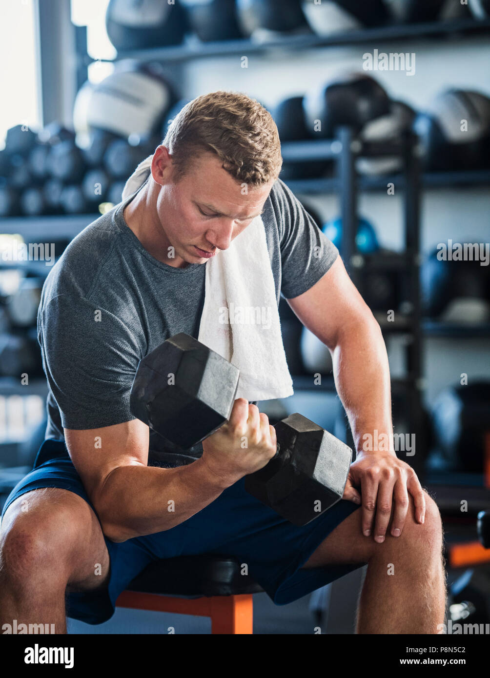 Mid adult man weight lifting Stock Photo - Alamy