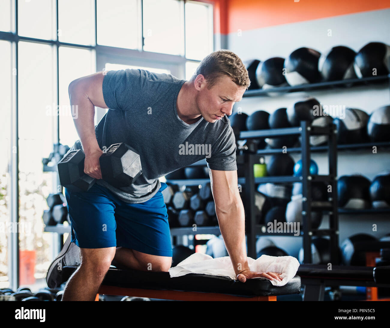 Mid adult man weight lifting Stock Photo - Alamy